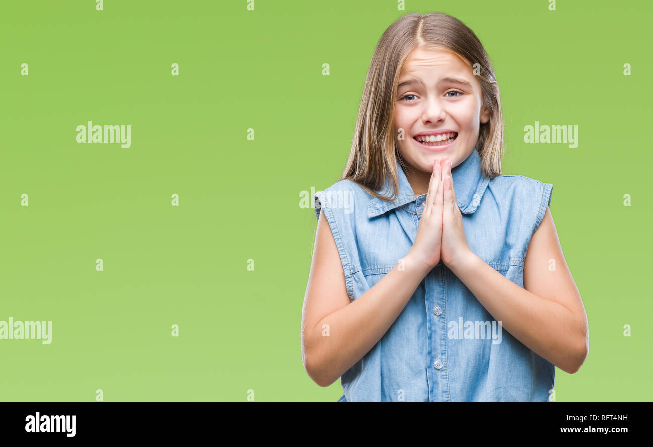 Young beautiful girl over isolated background begging and praying with ...