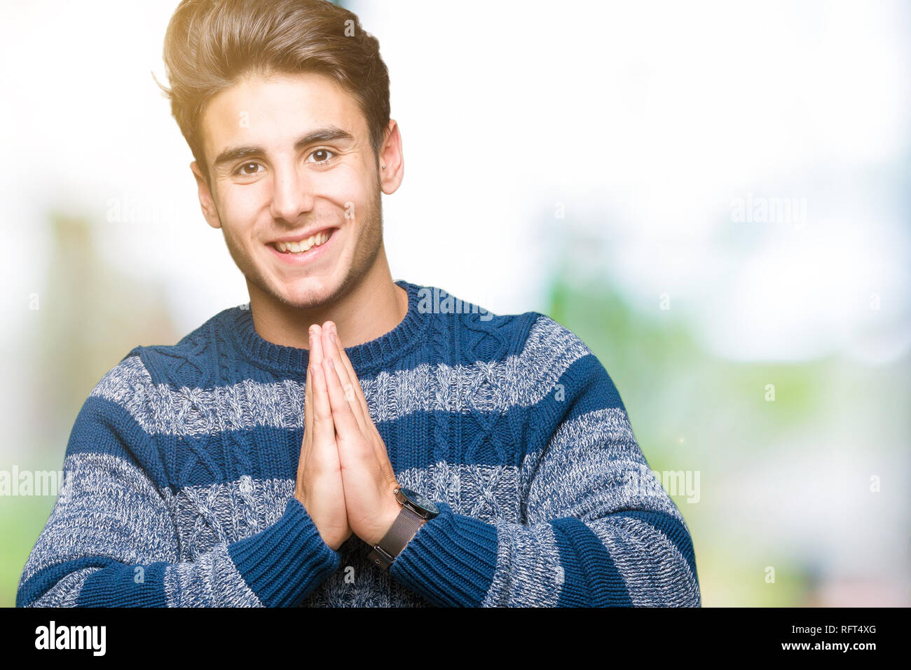 Young handsome man over isolated background begging and praying with ...