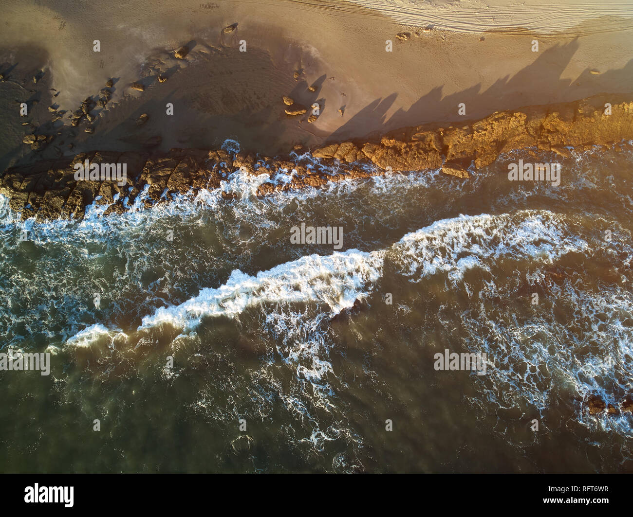Waves rock beach sea sky water sun sunset hi-res stock photography and ...