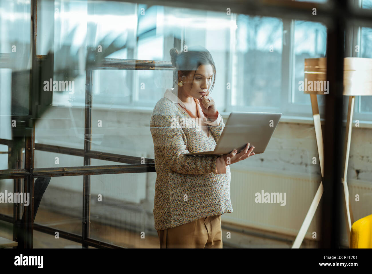 Dark-haired businesswoman feeling busy while reading business letter ...