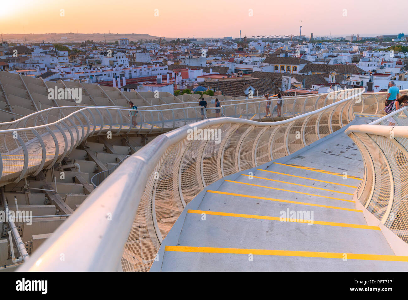 People on curved walkways admire the city skyline, Metropol Parasol ...