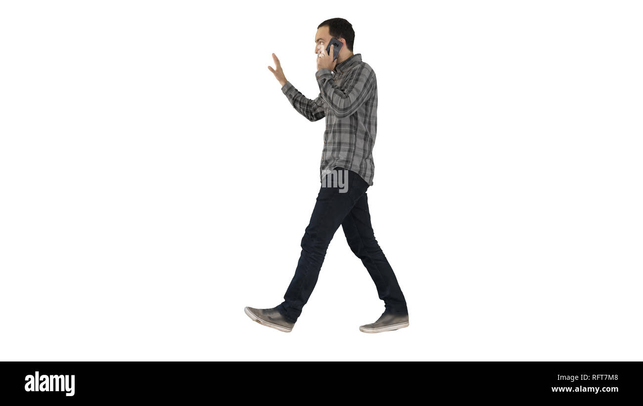 Full length portrait side view. Man talking on phone, walking and ...