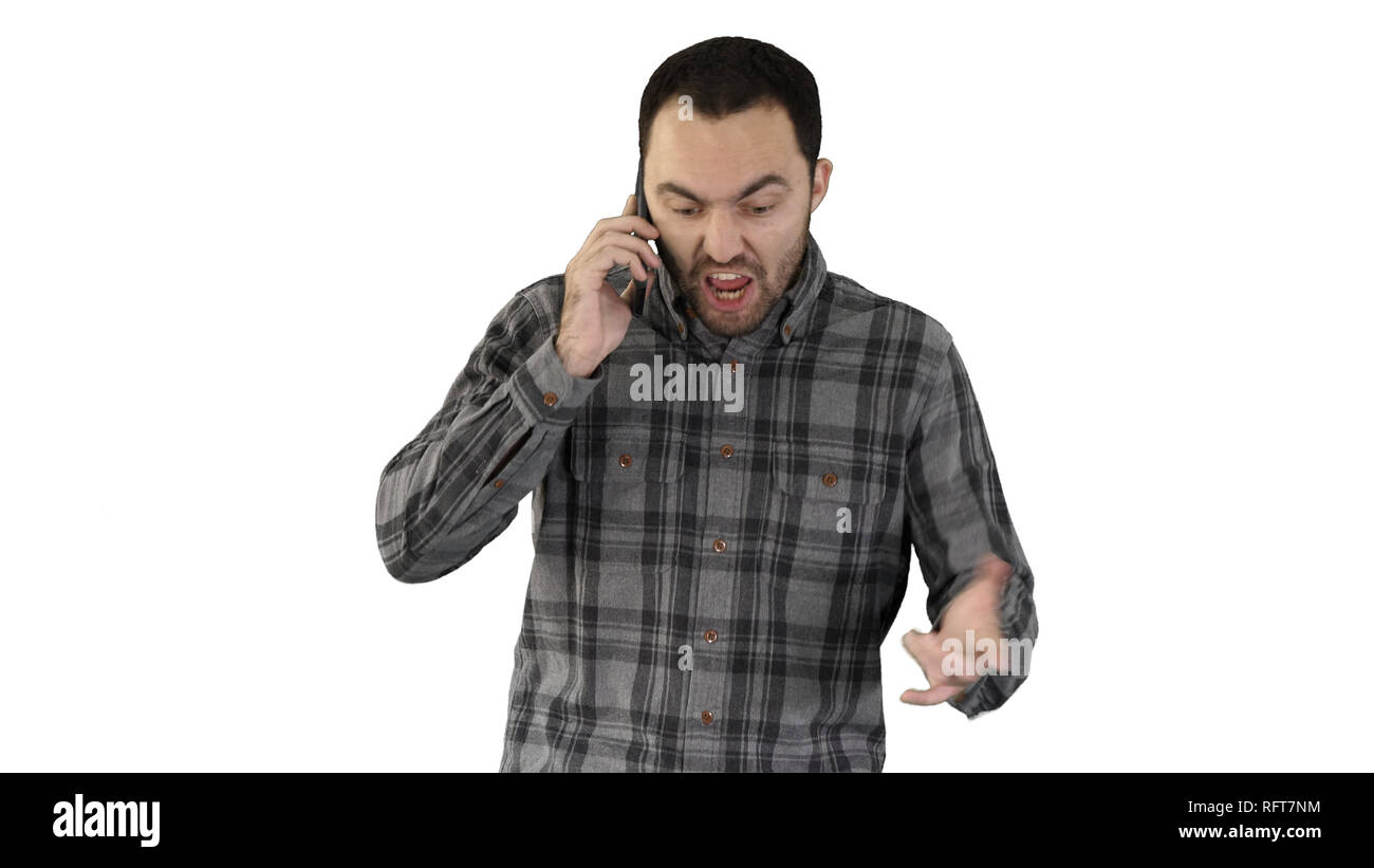 Medium shot. Man angry talking on telephone and walking on white ...