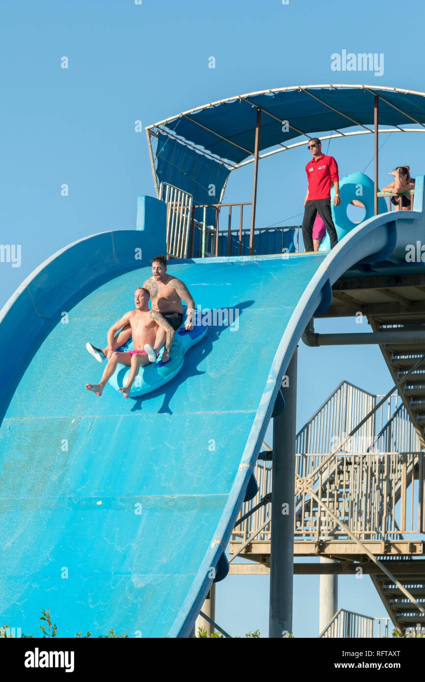 Couple sliding down water slide hi-res stock photography and images - Alamy
