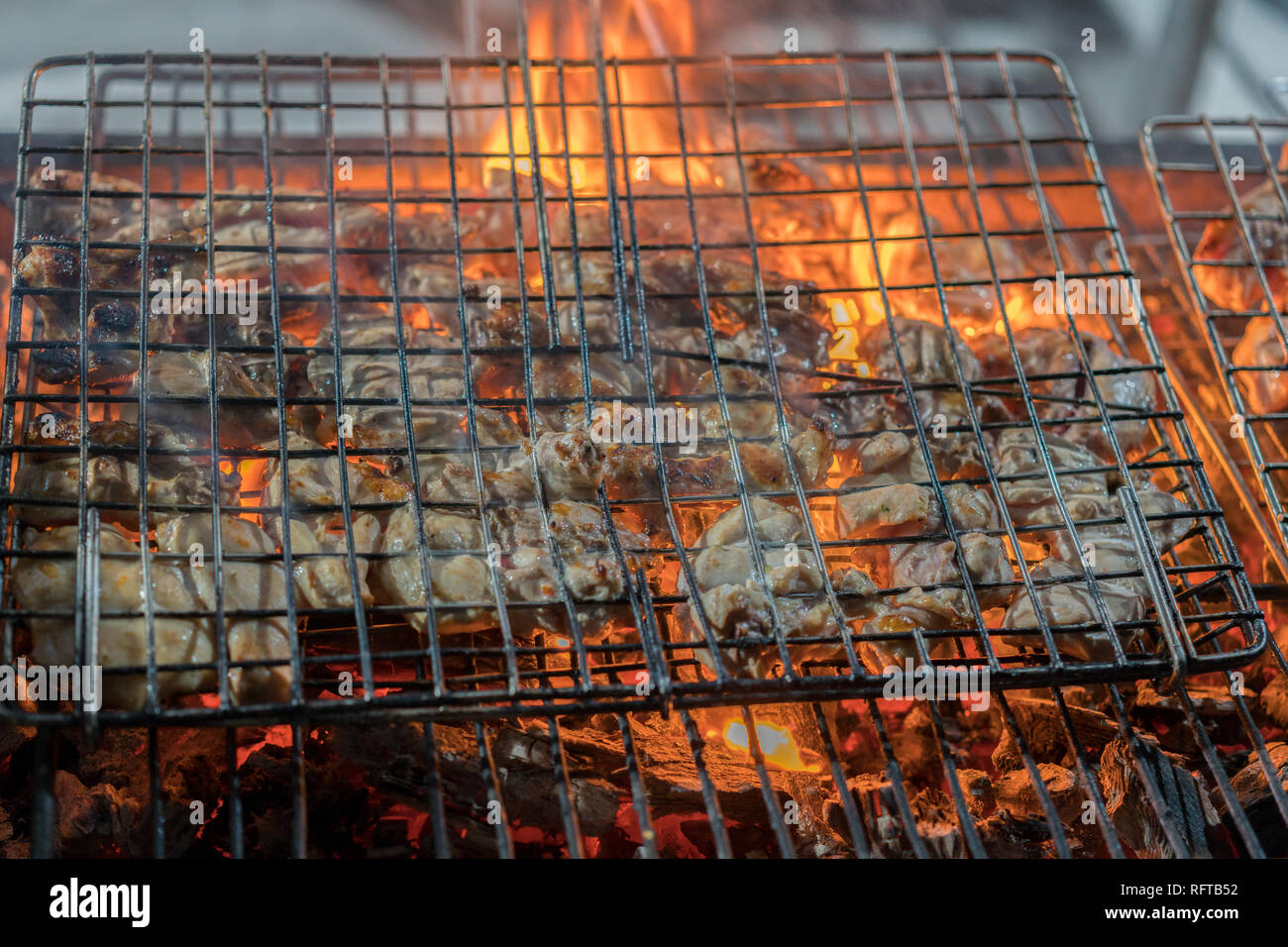 Chicken wings on barbecue grill with fire. Grilling chicken wings on ...