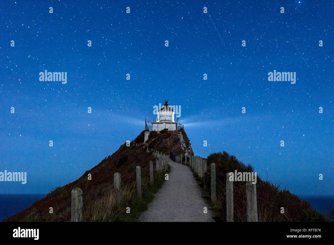 Nugget Point lighthouse under star filled sky, Kaka Point, Otago, South ...