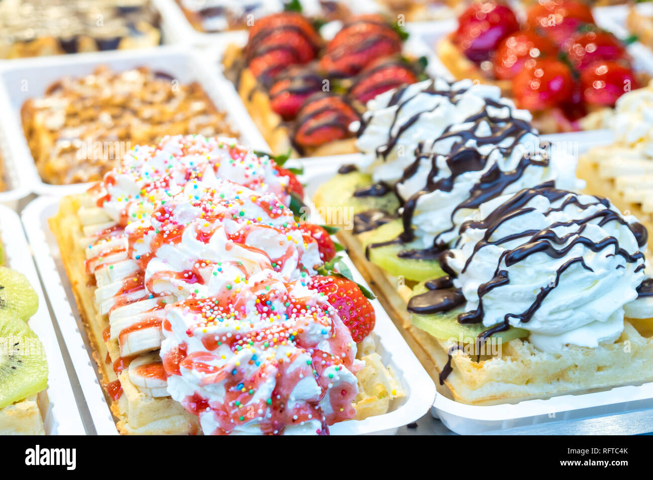colorful cake sweet dessert with whipped cream at a street food market ...