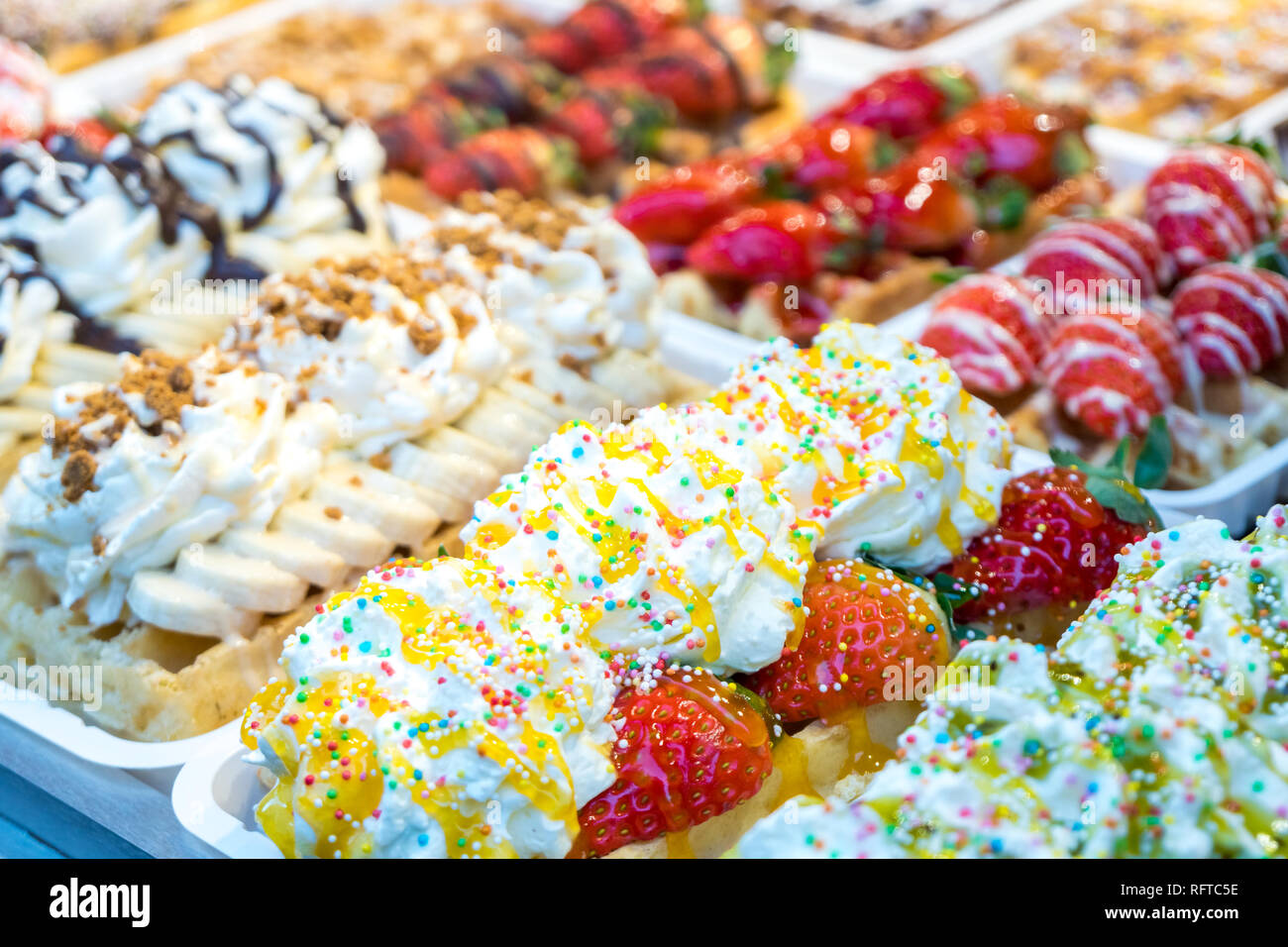 colorful cake sweet dessert with whipped cream at a street food market ...