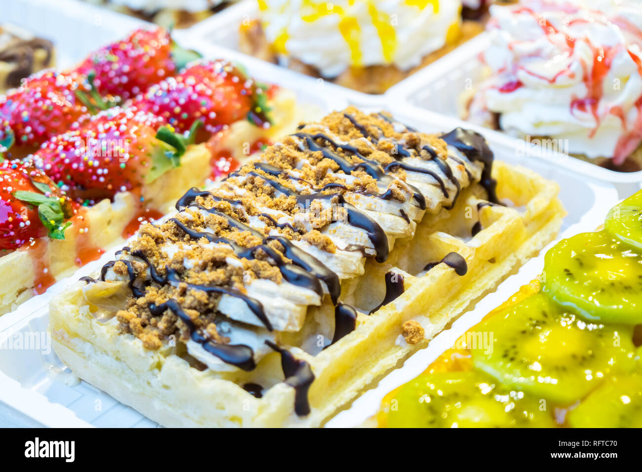 colorful cake sweet dessert with whipped cream at a street food market ...