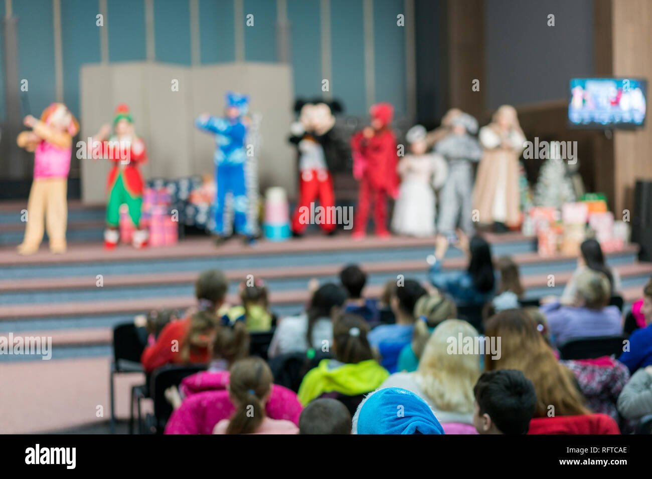 Performance for children on stage. Children on stage perform in front ...