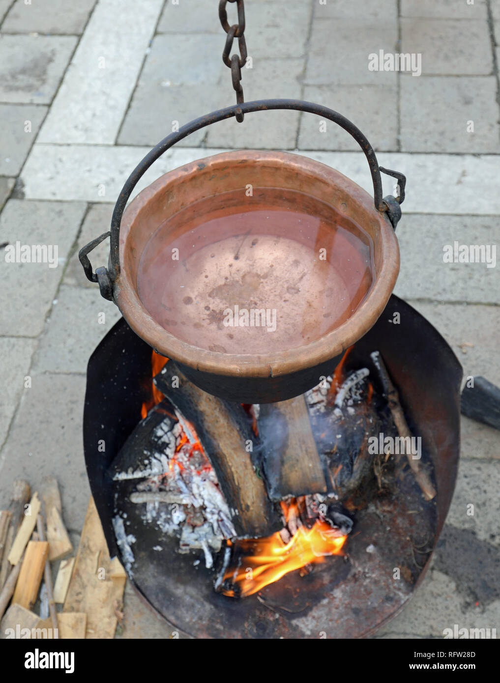 old cauldron of copper with boiling water and a wood fire below Stock ...