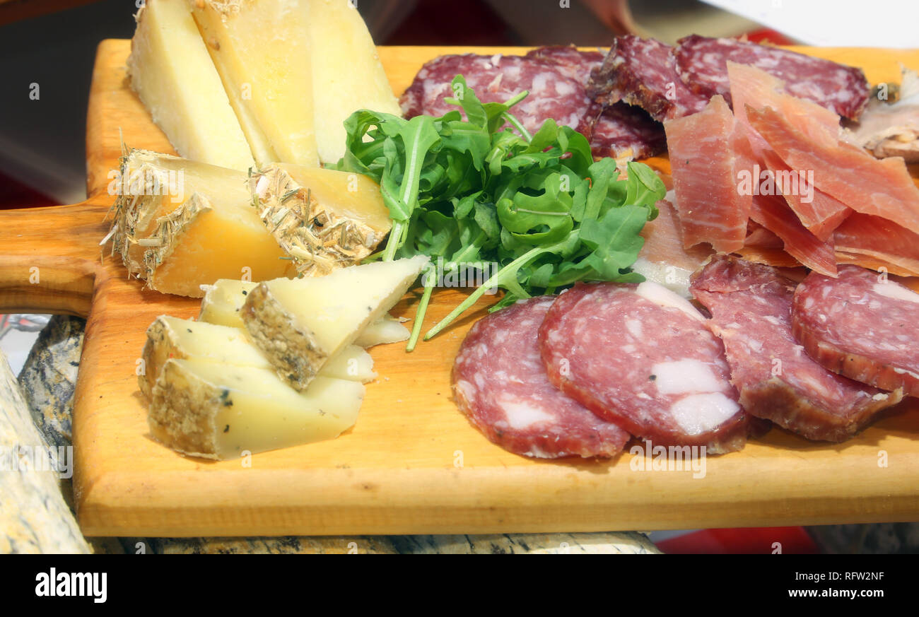 chopping board with cold cuts, cheese and rocket leaves Stock Photo - Alamy
