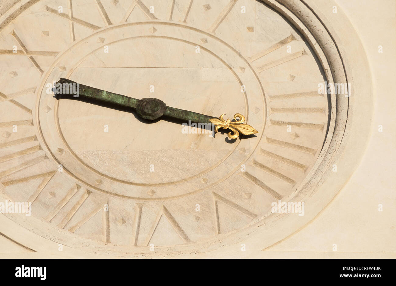Ancient times and hours. Old clock with lily-shape hand and roman ...