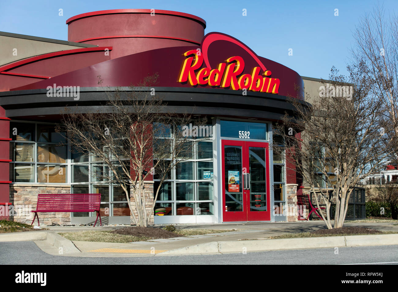 A logo sign outside of a Red Robin Gourmet Burgers and Brews restaurant ...