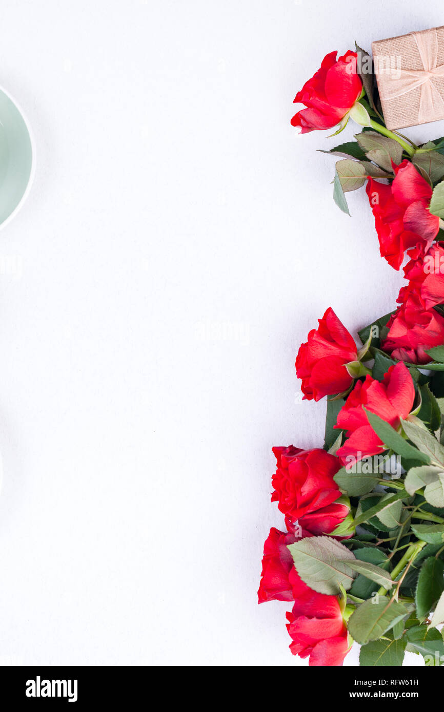 A large bouquet of red roses on a white background. Holiday card to the ...