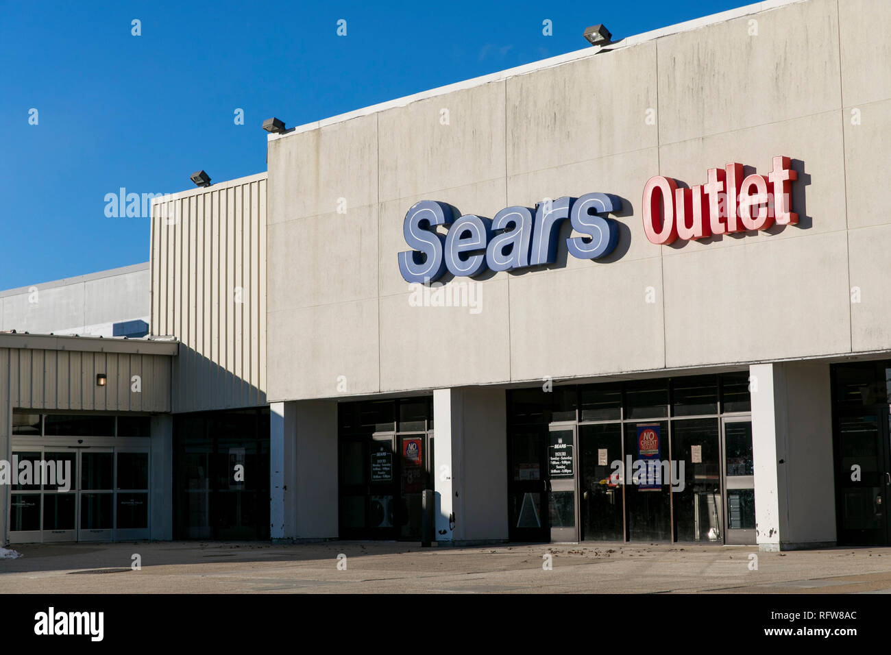 A logo sign outside of a Sears Outlet retail store location in ...