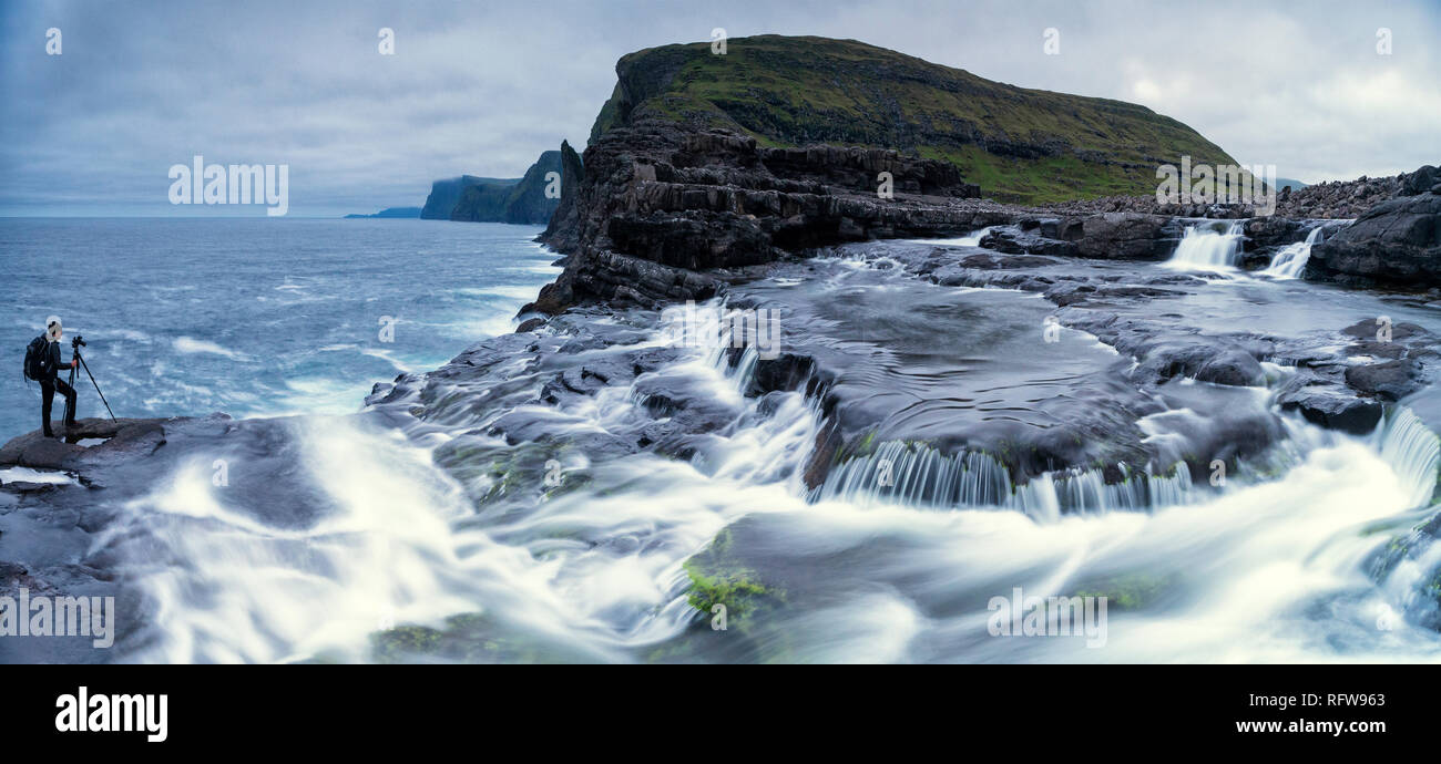 Panoramic of photographer at Bosdalafossur waterfall, Vagar island ...
