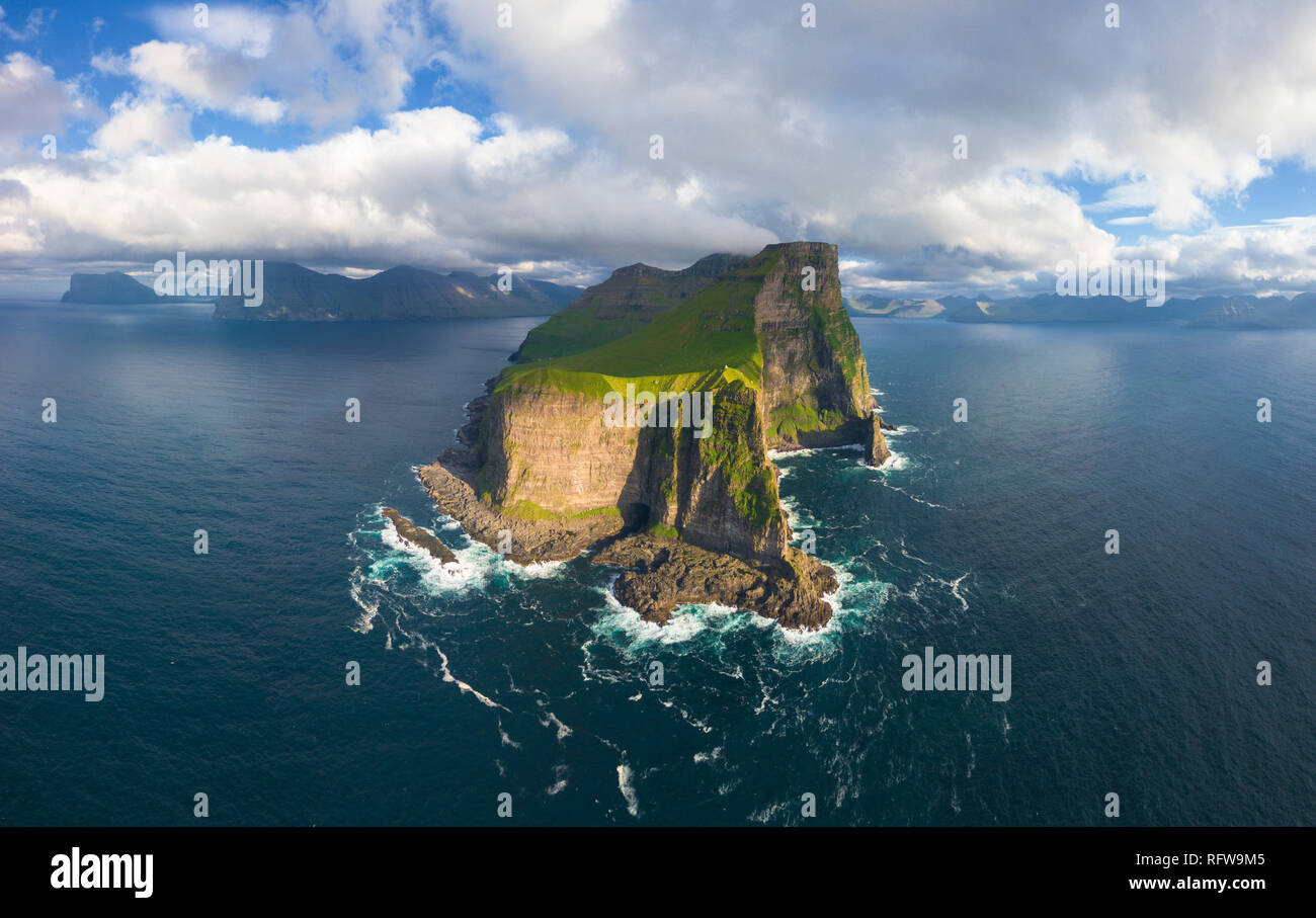 Aerial panoramic of Kallur lighthouse and cliffs, Kalsoy island, Faroe ...
