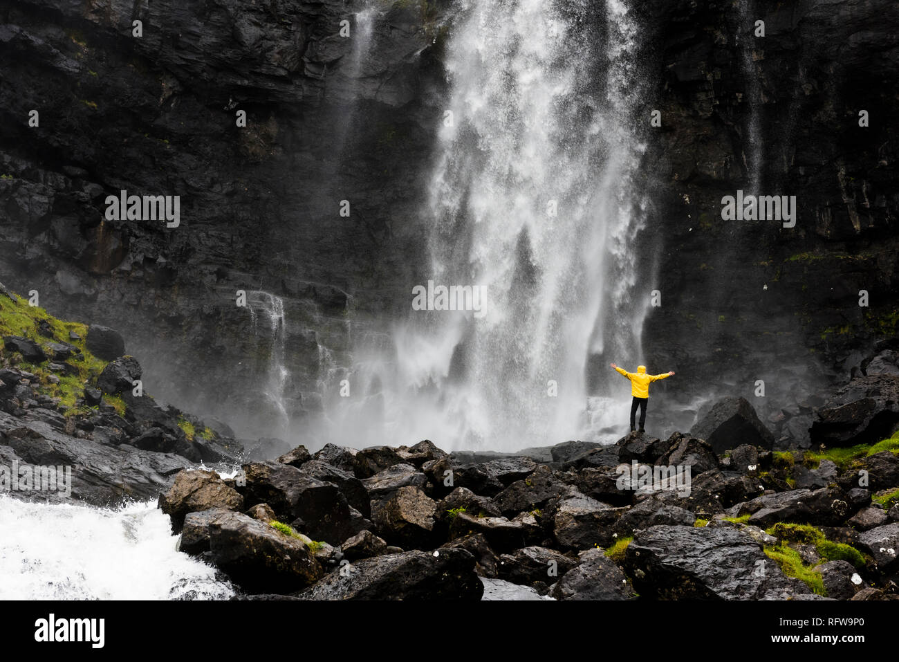Hiker at Fossa waterfall, Streymoy island, Faroe Islands, Denmark ...