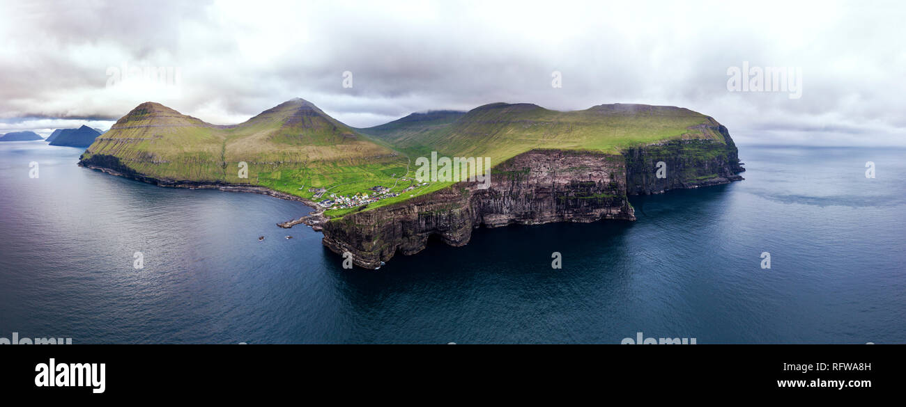 Panoramic aerial view of cliffs and village of Gjogv, Eysturoy island ...