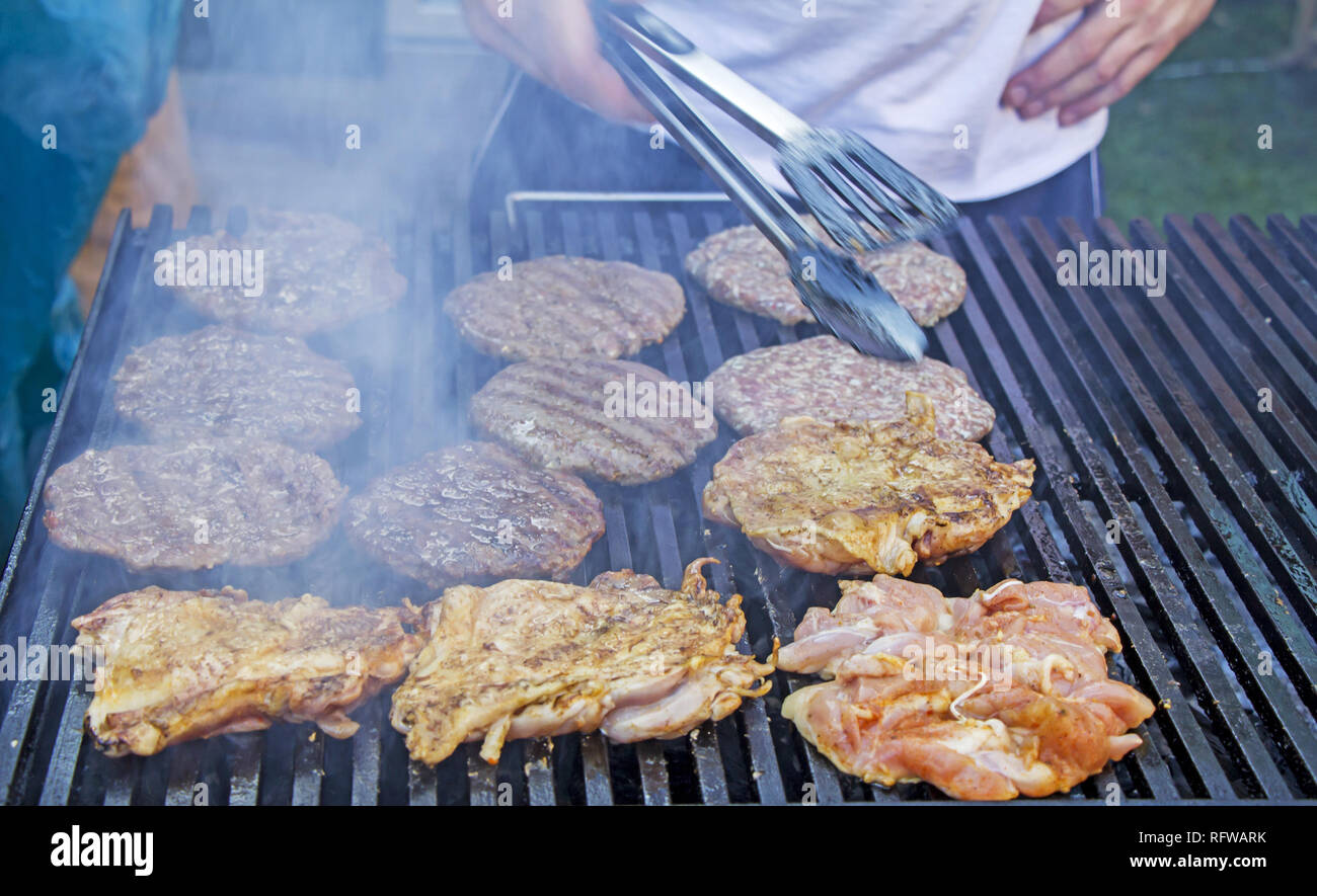 Chef preparing burgers at the barbecue outdoors Stock Photo - Alamy