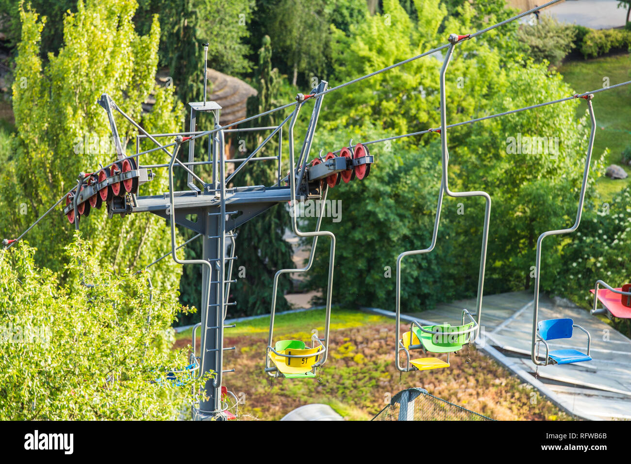 Colorful chair lifts, funicular, in Prague ZOO. Lift station and cable ...