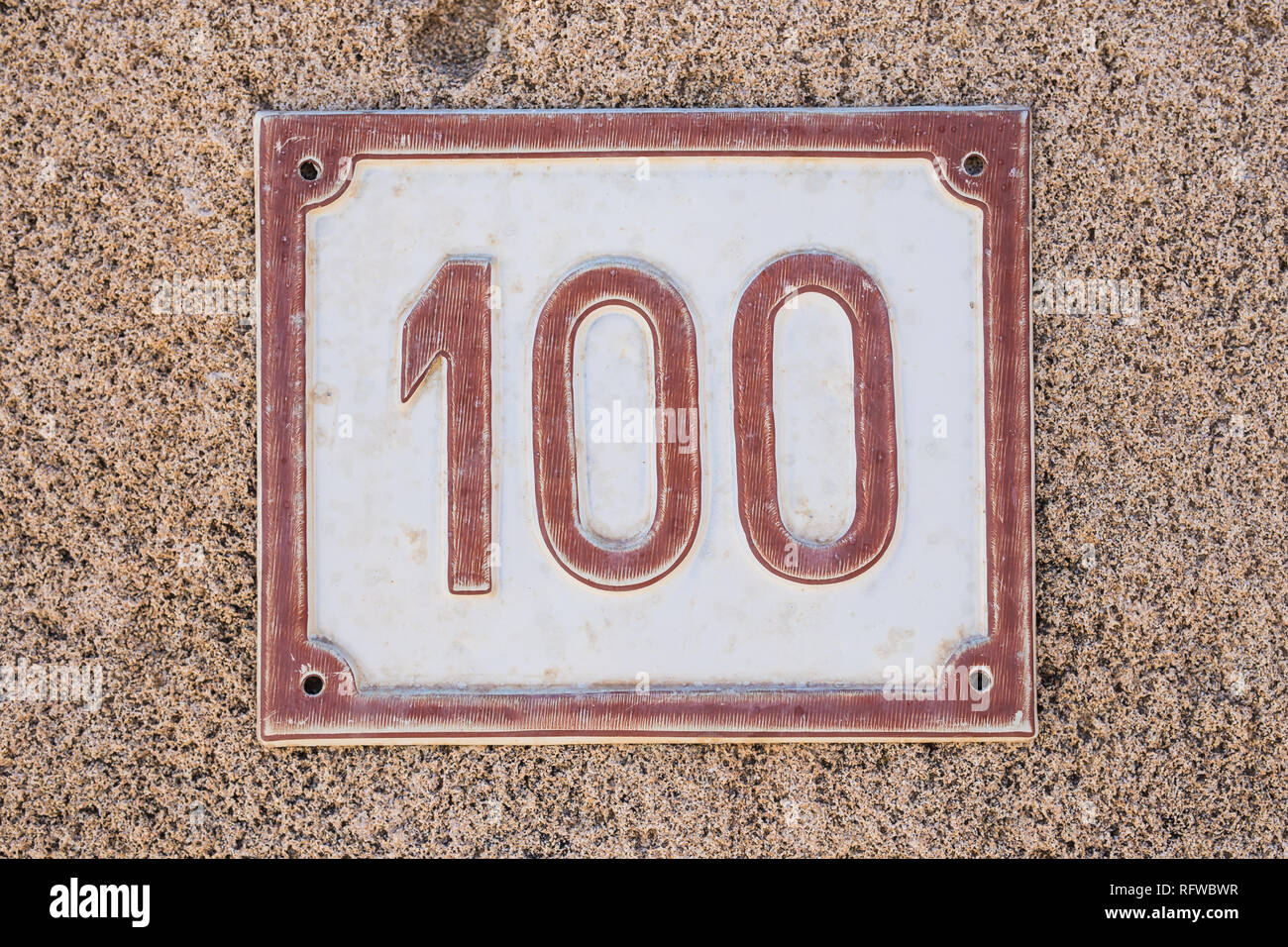 House number one hundred. Red lettering on white background Stock Photo ...