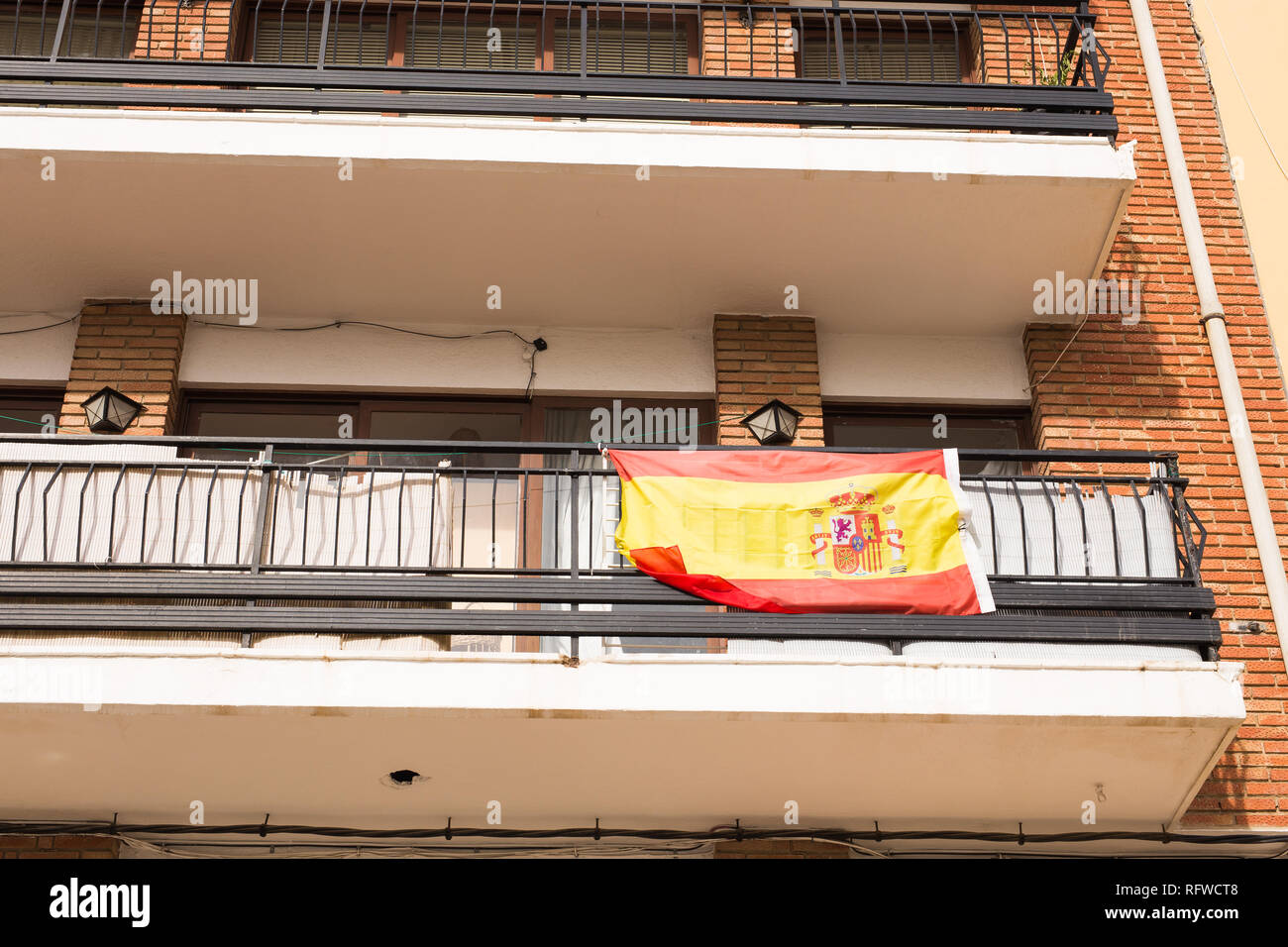 Flag of Spain hanging on the balcony of a house Stock Photo - Alamy