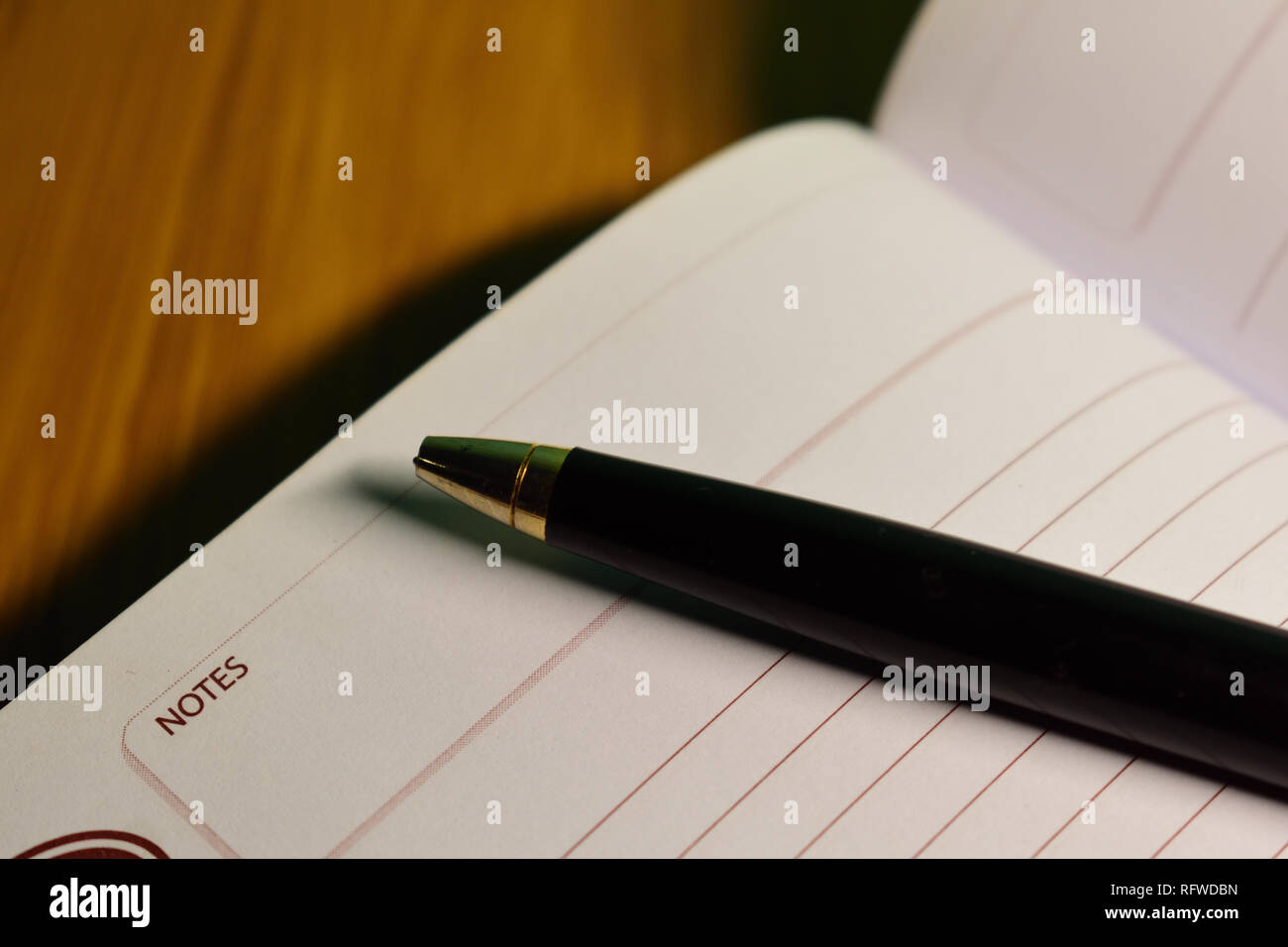 A ball pen on an open notebook Stock Photo - Alamy