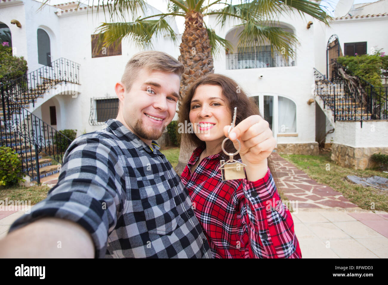 Property, real estate and apartment concept - Happy funny young couple ...