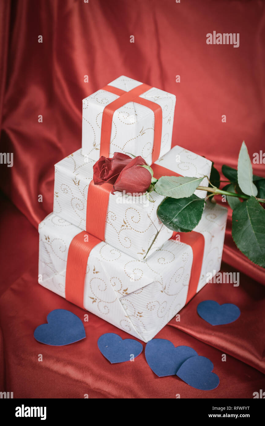 gift box and rose on red background Stock Photo - Alamy