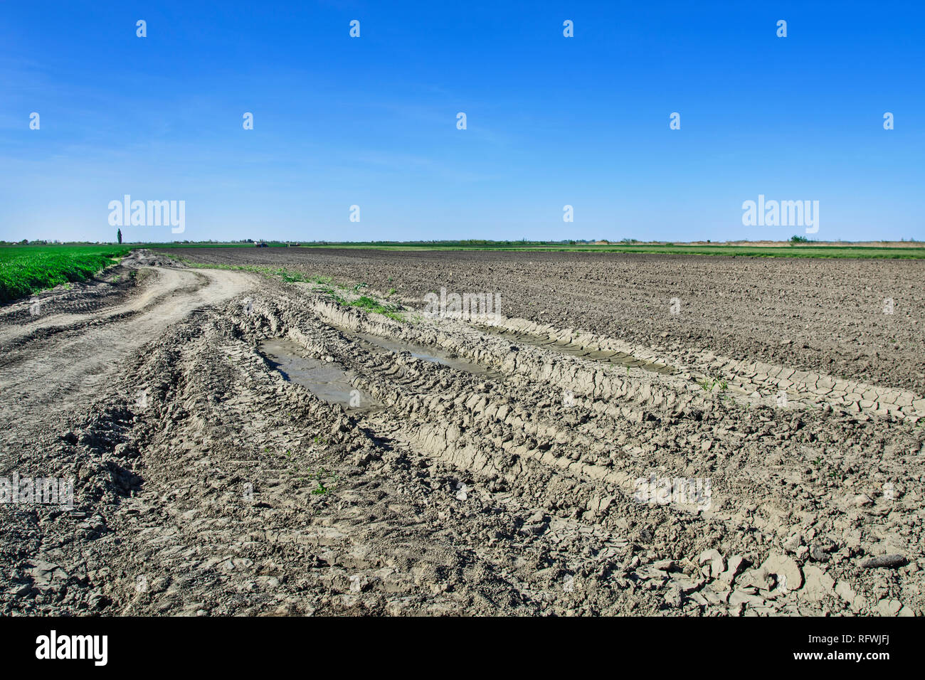 Rural old tractor path through fields where passing heavy machinery ...