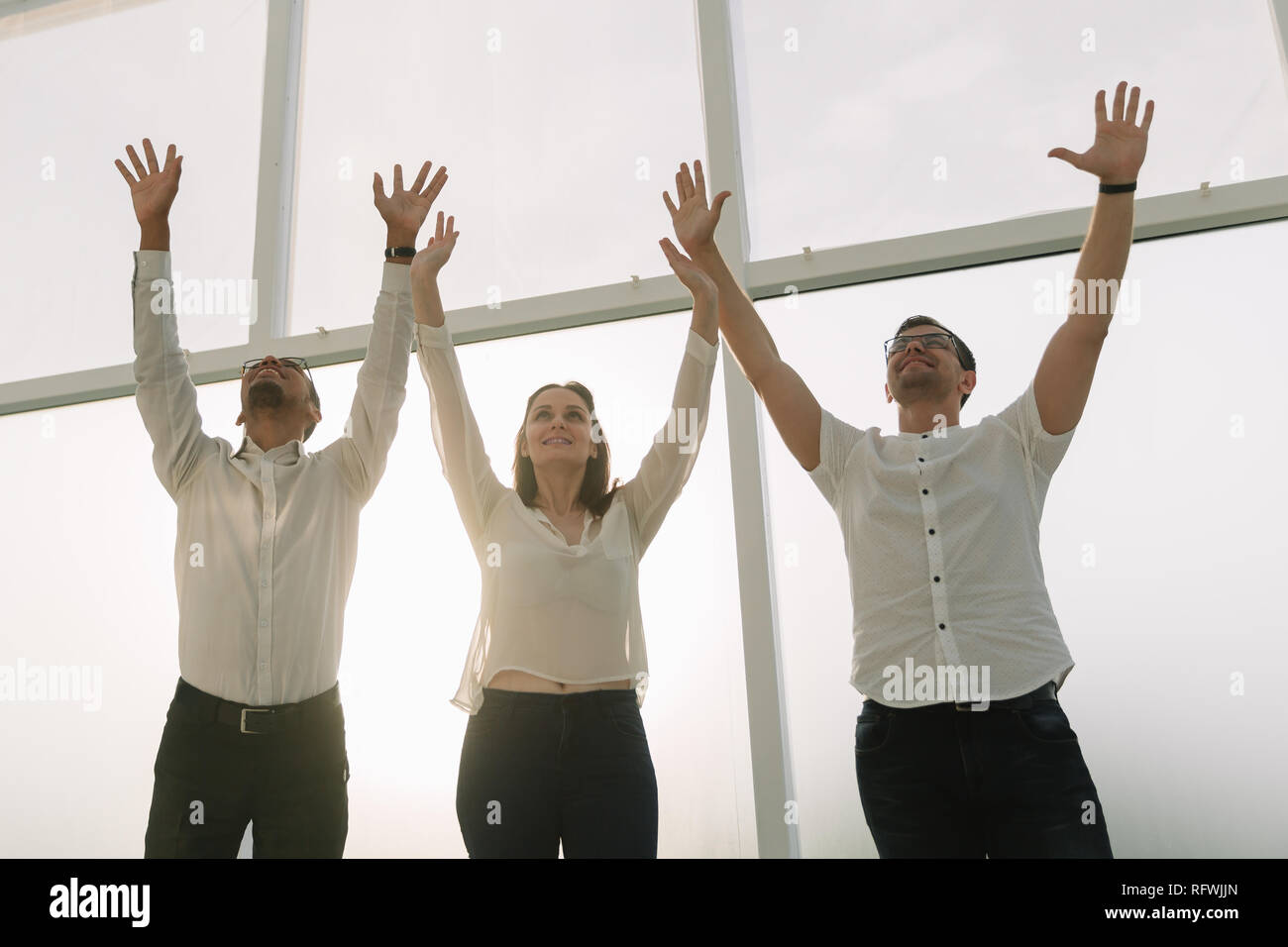 successful business team stands with hands up Stock Photo - Alamy