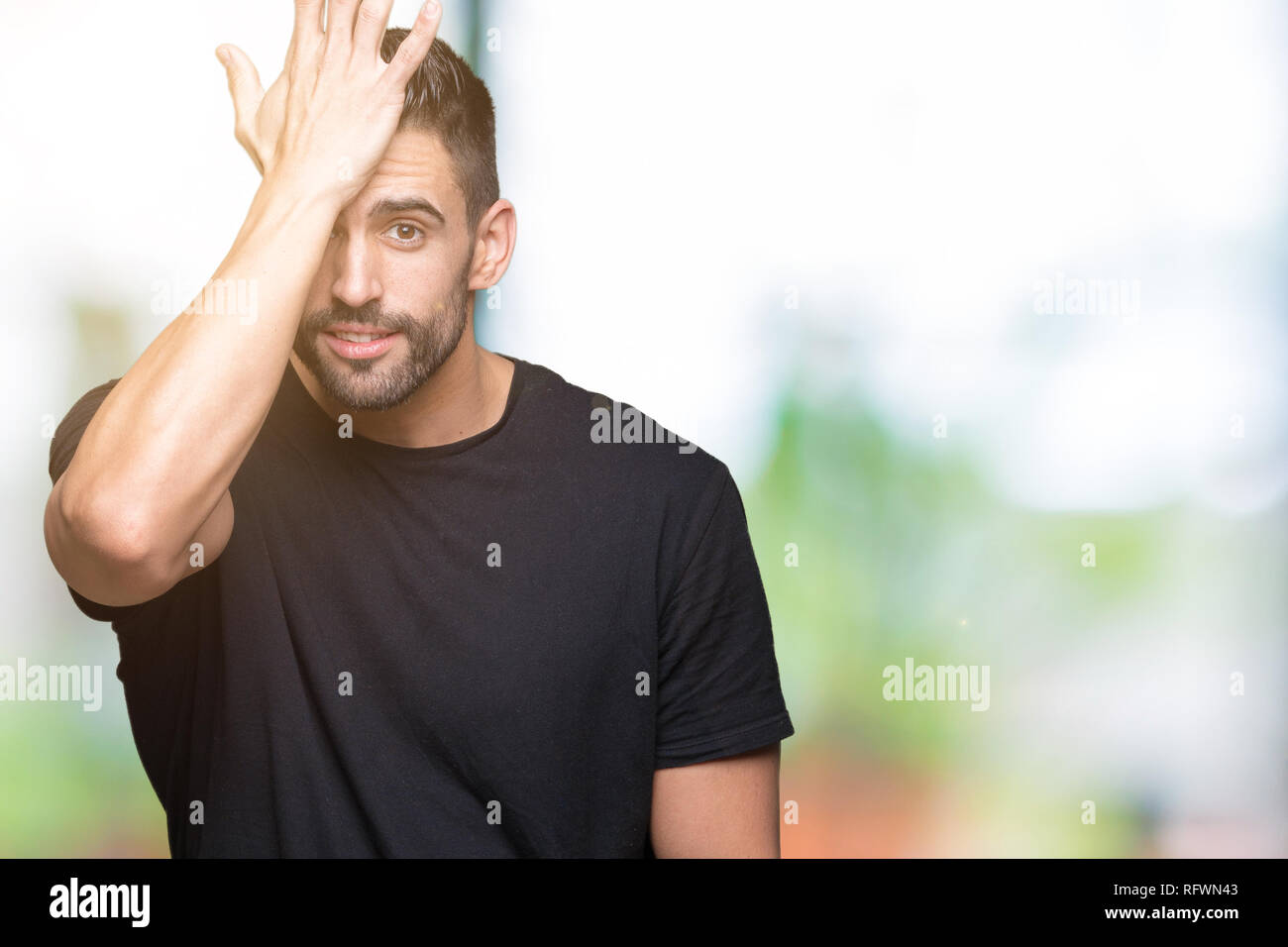 Young handsome man over isolated background surprised with hand on head ...