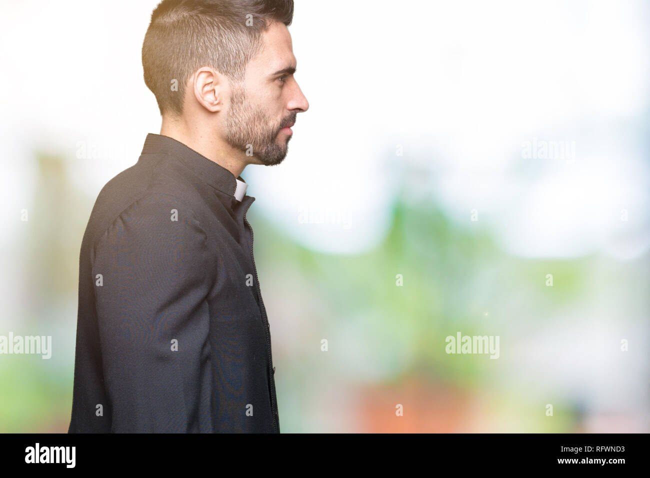 Young Christian priest over isolated background looking to side, relax ...