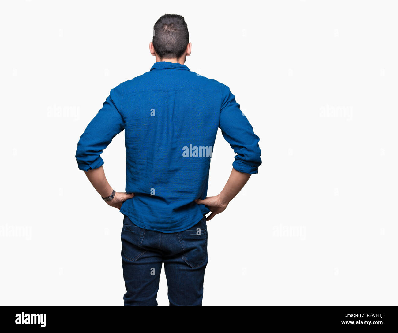 Young handsome man over isolated background standing backwards looking ...