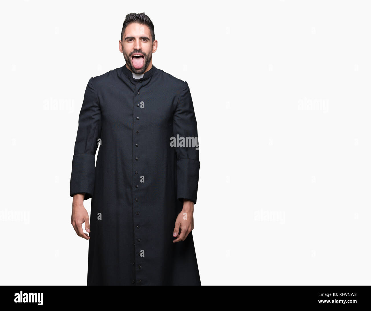 Young Christian priest over isolated background sticking tongue out ...