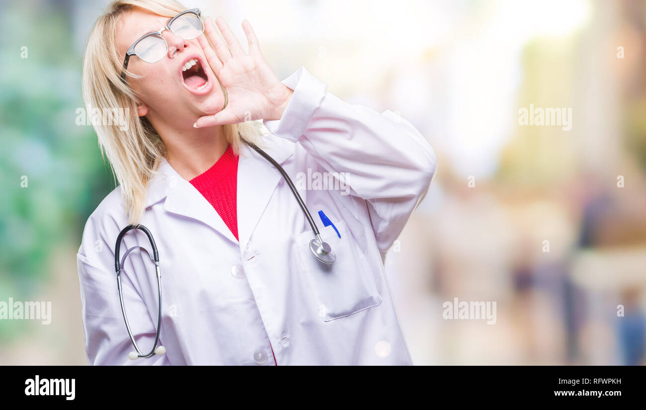 Young beautiful blonde doctor woman wearing medical uniform over ...