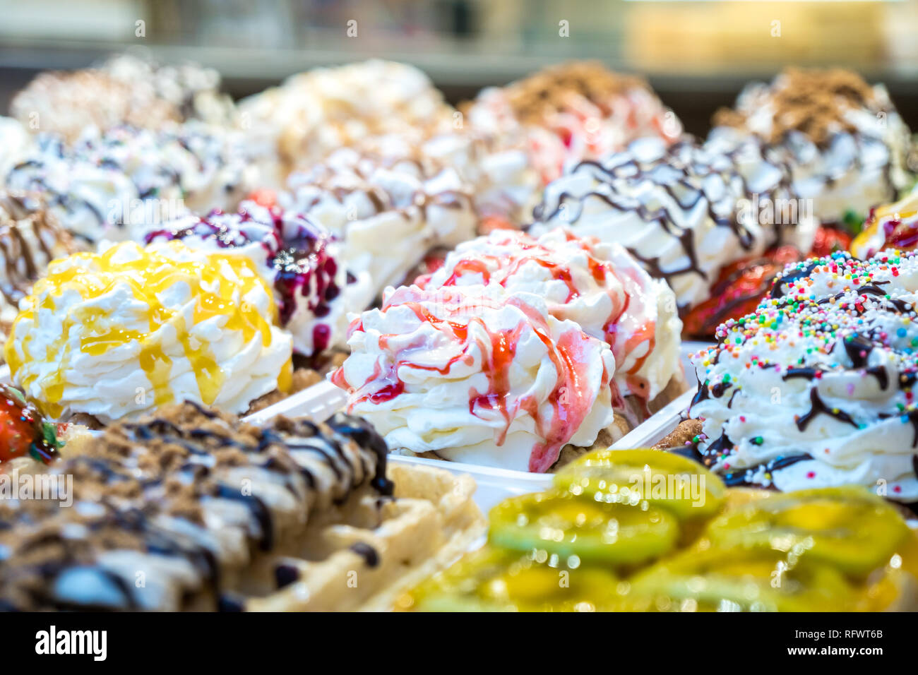 colorful cake sweet dessert with whipped cream at a street food market ...