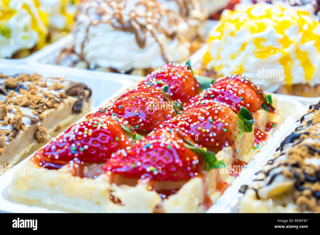 colorful cake sweet dessert with whipped cream at a street food market ...