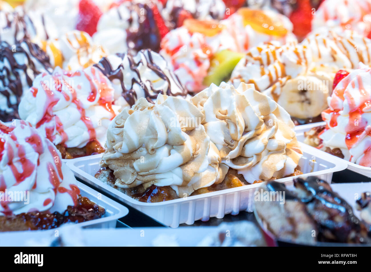 colorful cake sweet dessert with whipped cream at a street food market ...