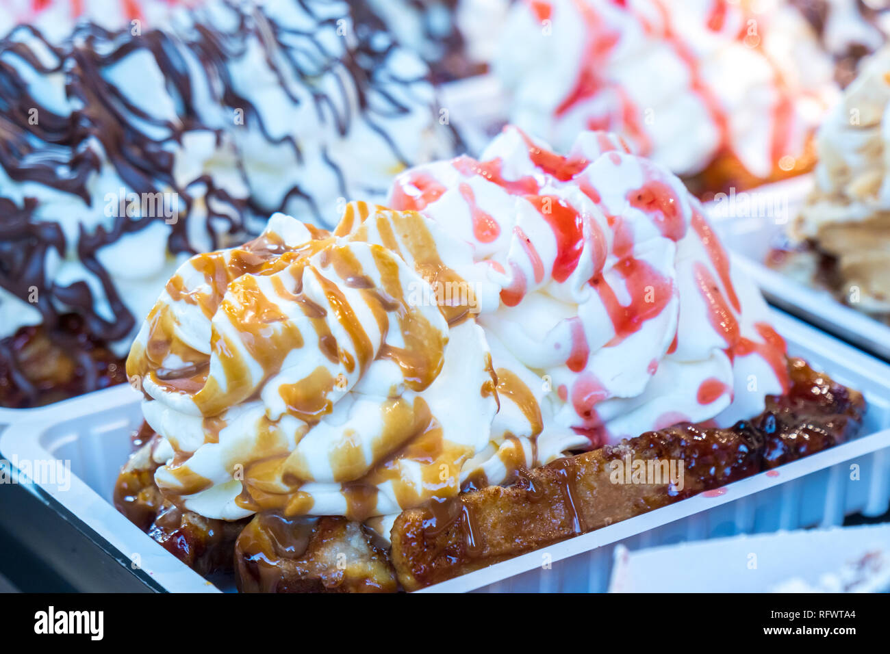 colorful cake sweet dessert with whipped cream at a street food market ...