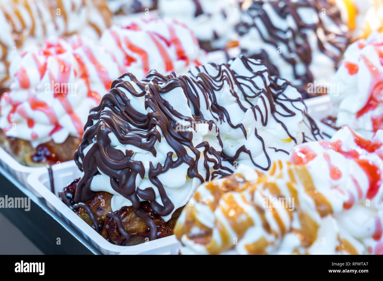 colorful cake sweet dessert with whipped cream at a street food market ...