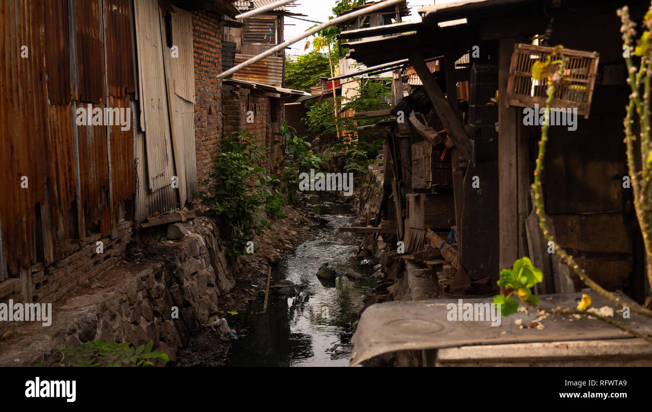 Poor area with slums and sewers in Indonesia. Poor asian city block ...