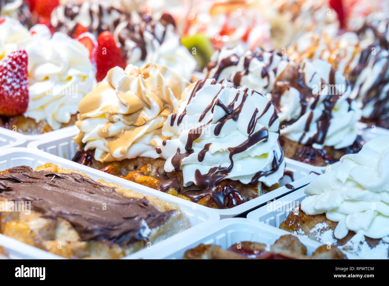 colorful cake sweet dessert with whipped cream at a street food market ...