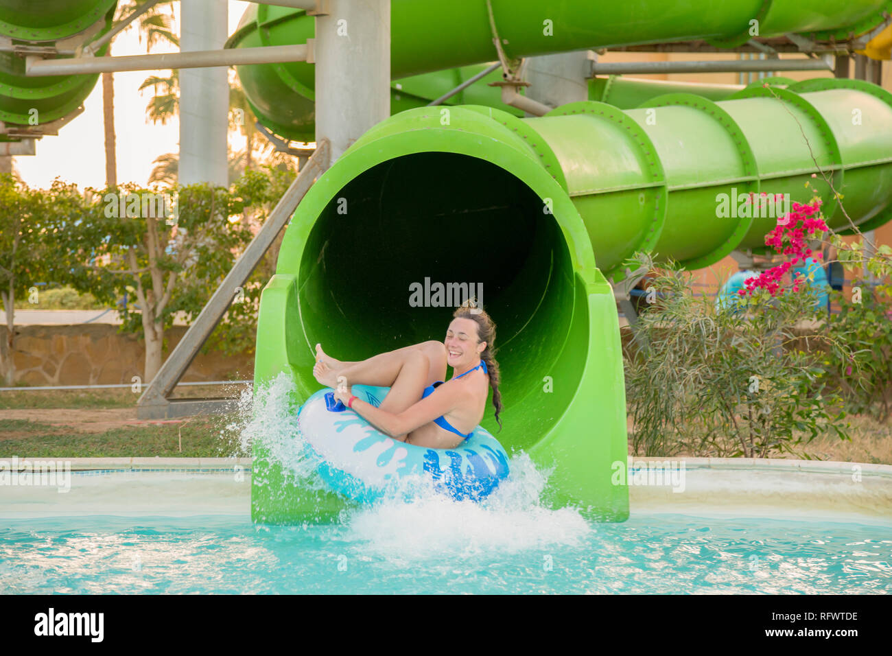 Happy boy going down slide hi-res stock photography and images - Alamy