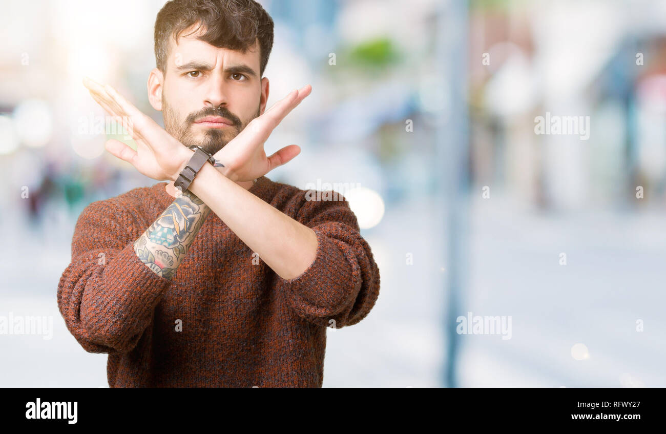 Young handsome man wearing winter sweater over isolated background ...