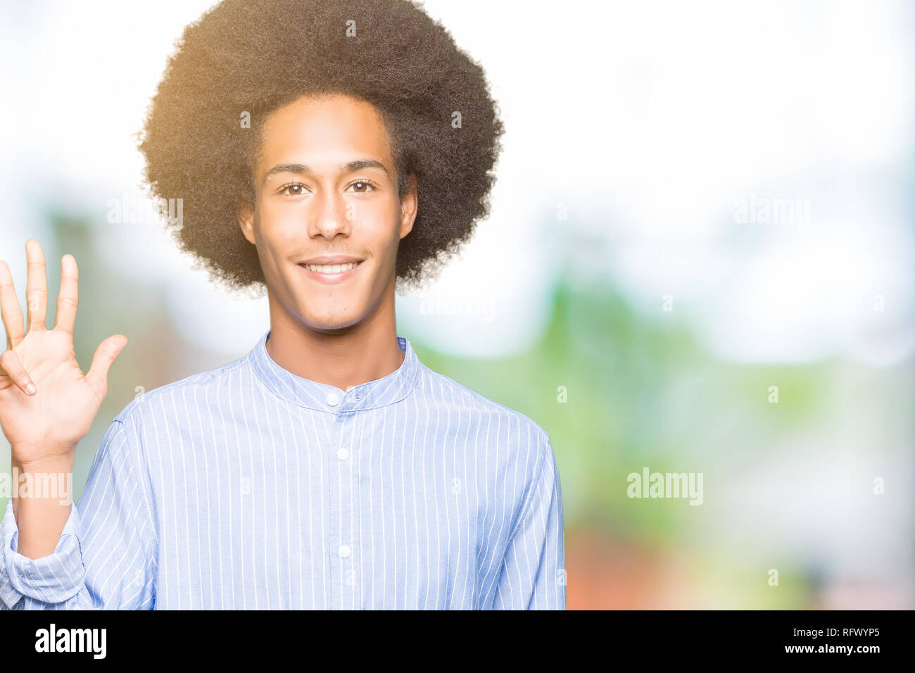 Young african american man with afro hair showing and pointing up with ...
