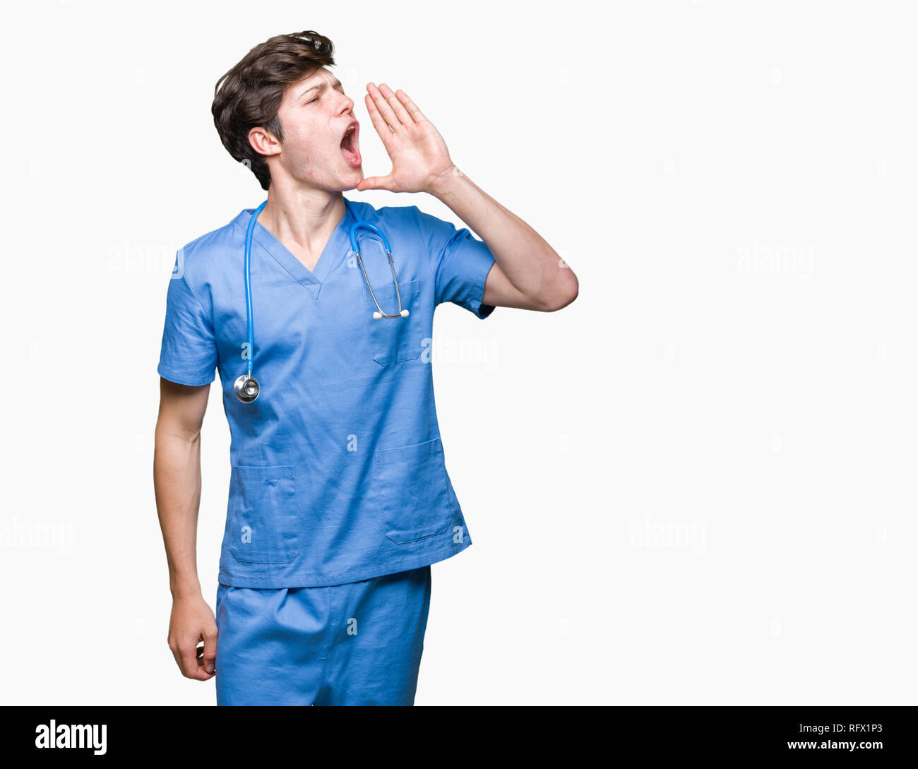 Young doctor wearing medical uniform over isolated background shouting ...