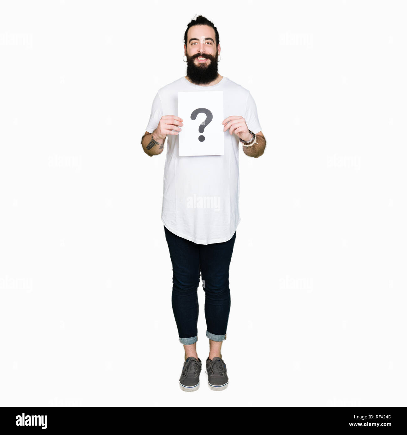 Young man with long hair and bear holding a paper with question mark ...